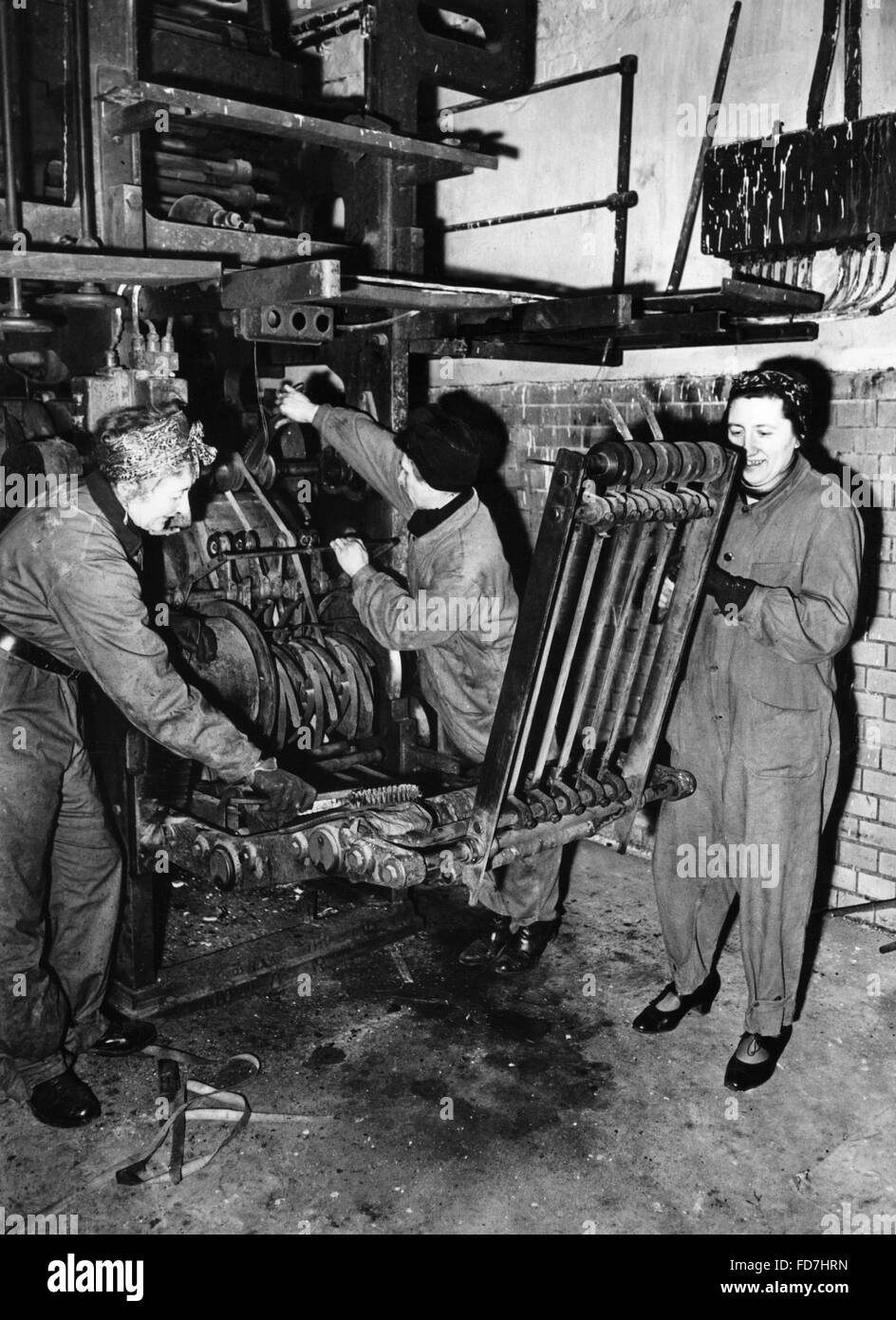 Cleaning a machine, 1943 Stock Photo - Alamy