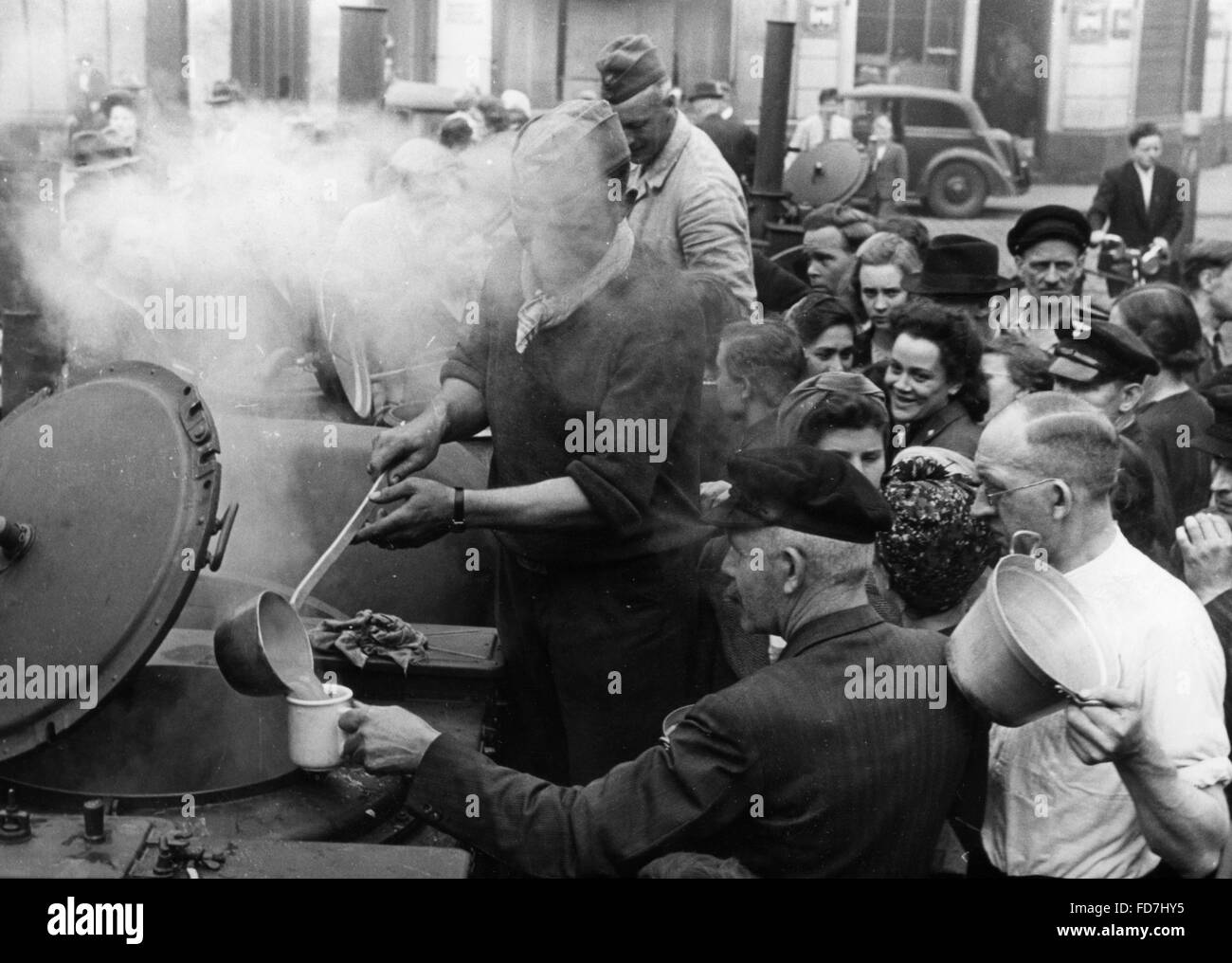 People affected by air raids receive food in Cologne, 1943 Stock Photo ...