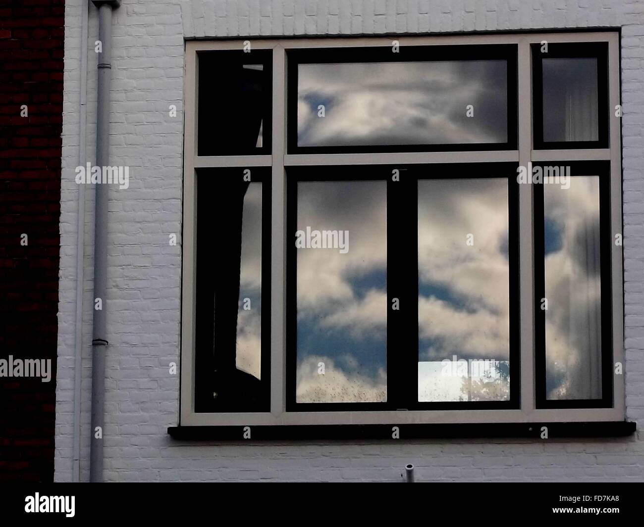 Reflection Of Clouds On House Window Stock Photo - Alamy
