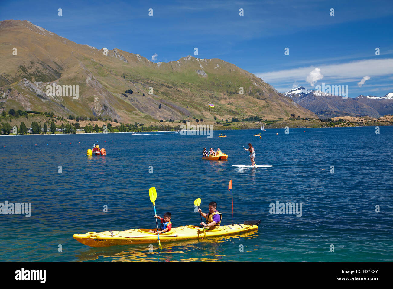 Kayakers and Lake Wanaka waterfront in summer, Wanaka, Otago, South ...