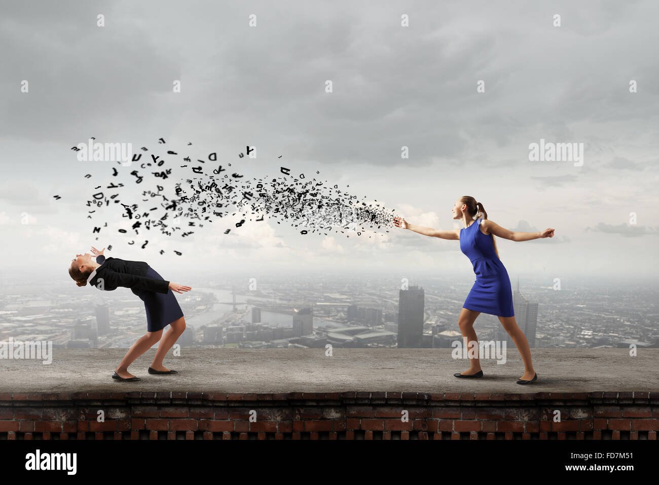 Young businesswoman benting back from flying characters Stock Photo - Alamy