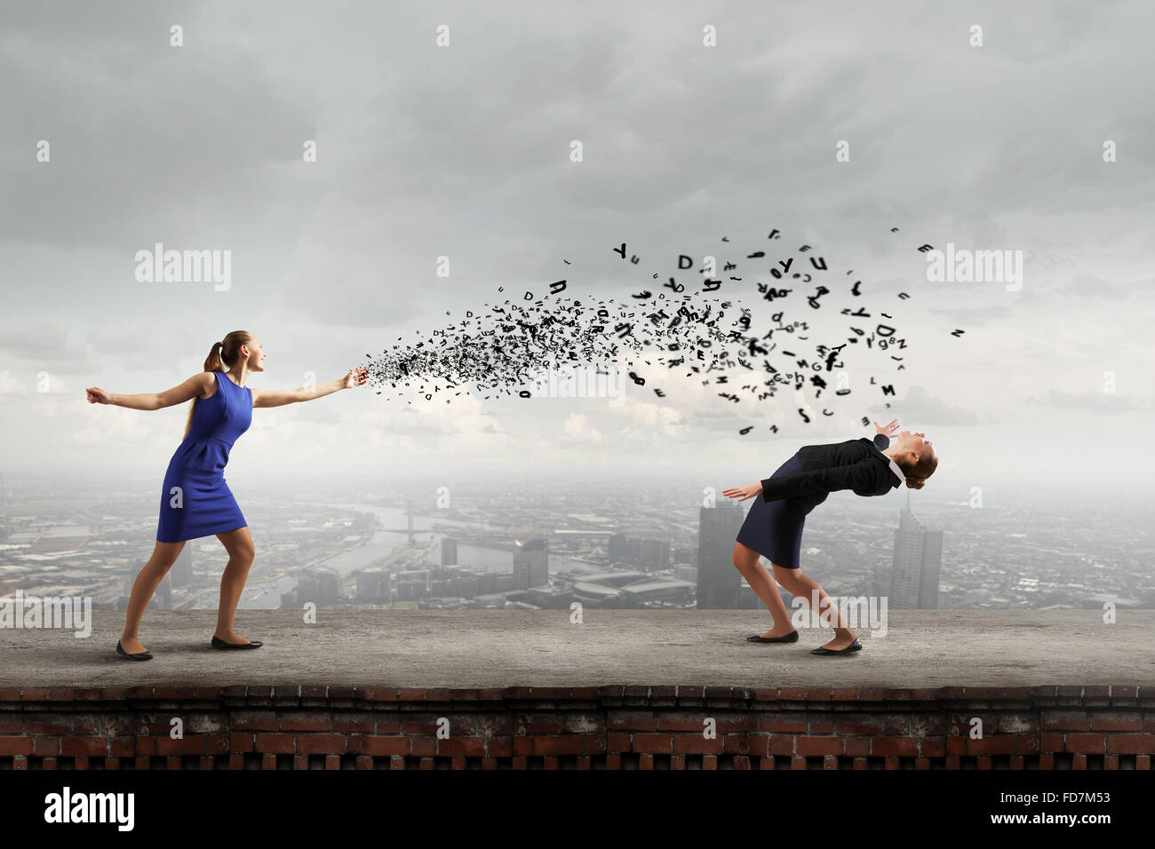 Young businesswoman benting back from flying characters Stock Photo - Alamy