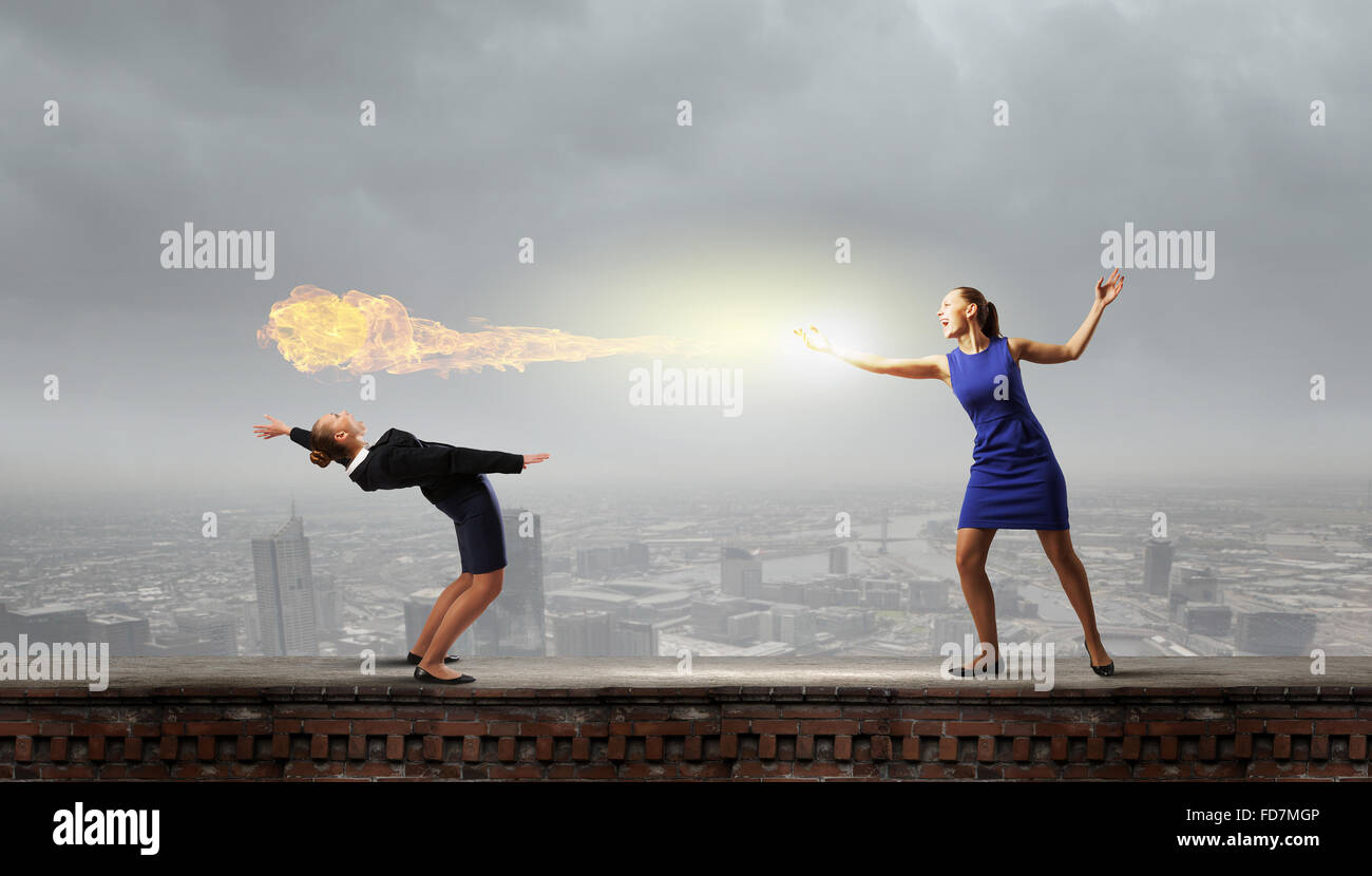 Young businesswoman benting back to evade from fire Stock Photo - Alamy