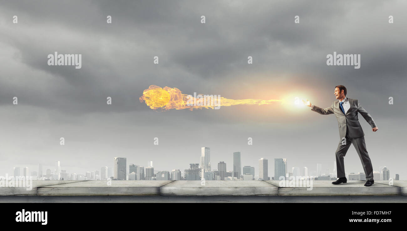 Young man in casual throwing fire flames Stock Photo - Alamy