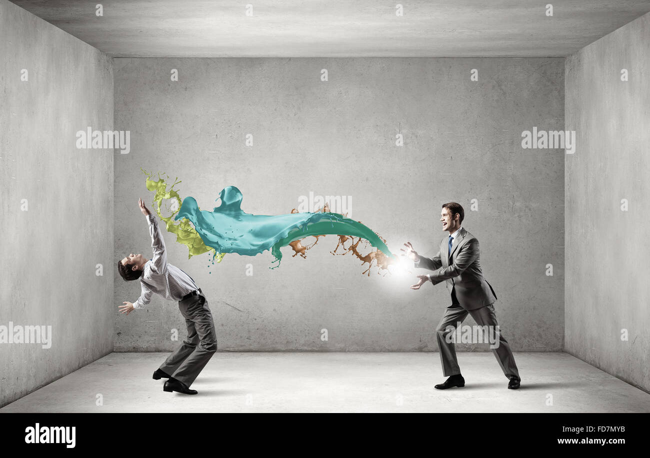 Young businessman trying to evade from thrown splashes Stock Photo - Alamy