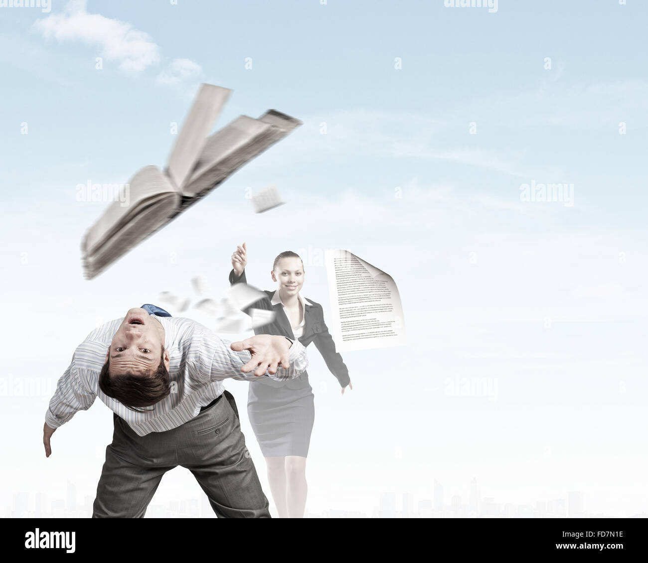 Young businessman trying to evade from thrown book Stock Photo - Alamy