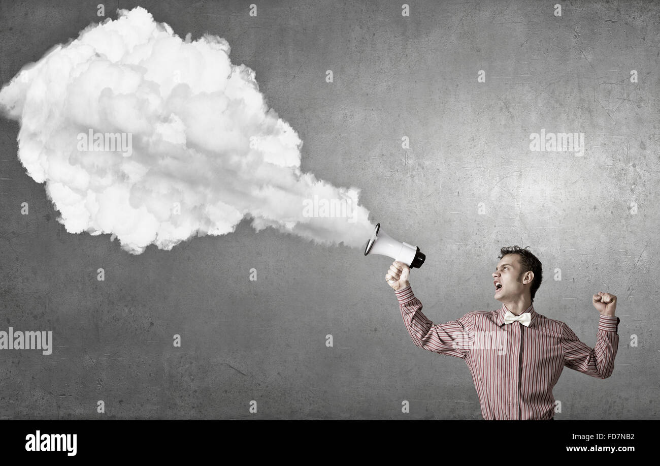 Young funny man screaming emotionally in megaphone Stock Photo - Alamy