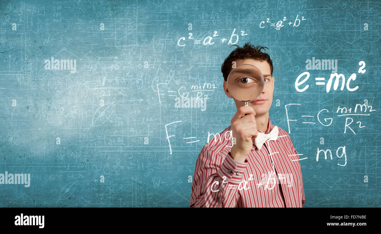 Funny image of young man looking in magnifying glass Stock Photo - Alamy