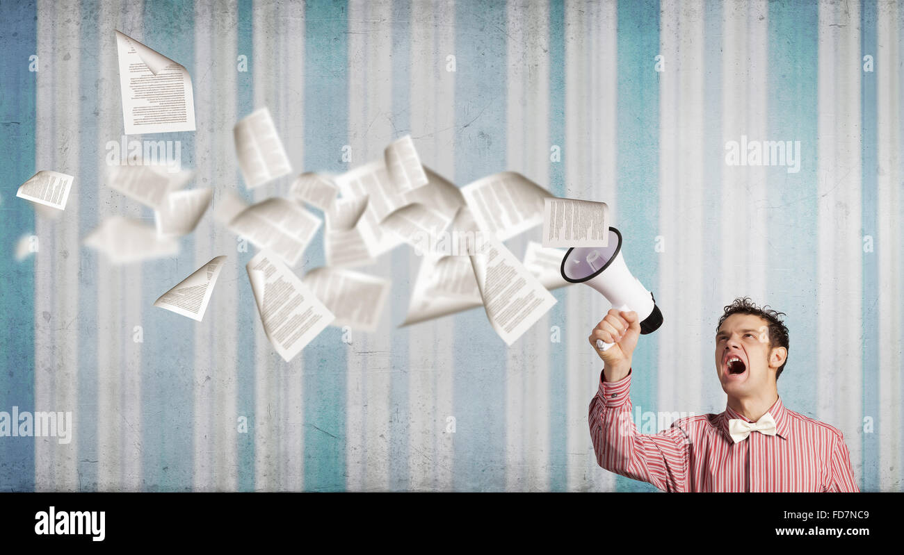 Young funny man screaming emotionally in megaphone Stock Photo - Alamy