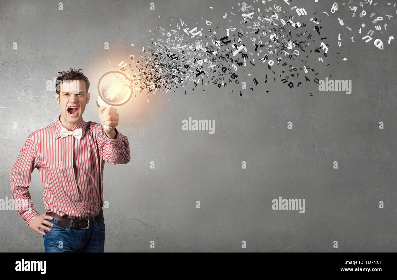 Young funny man screaming emotionally in megaphone Stock Photo - Alamy