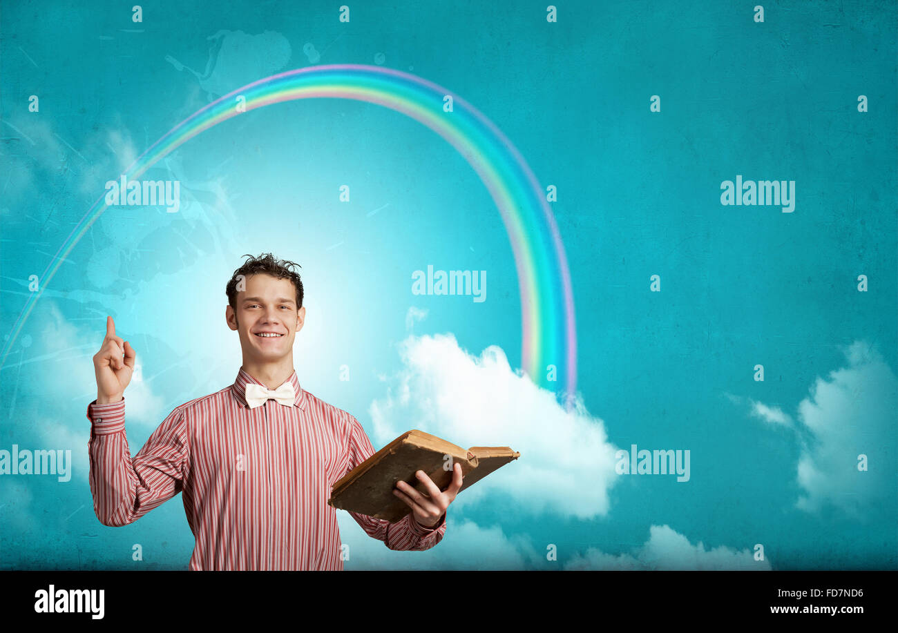 Young funny man with book in hands Stock Photo - Alamy