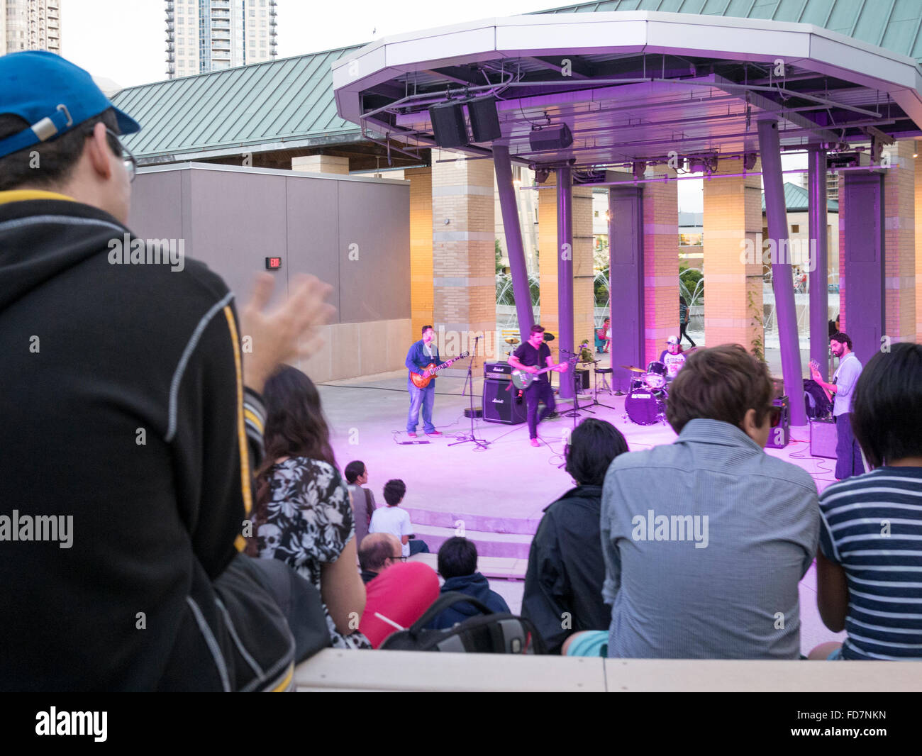 Band performing in an amphitheater to an audience Stock Photo - Alamy
