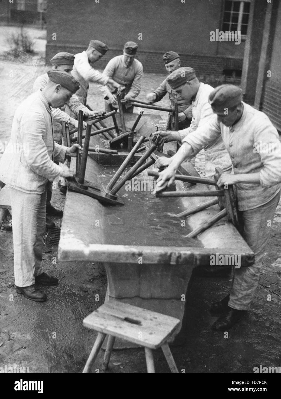 Recruits of the German Wehrmacht cleaning chairs in the 30s Stock Photo ...