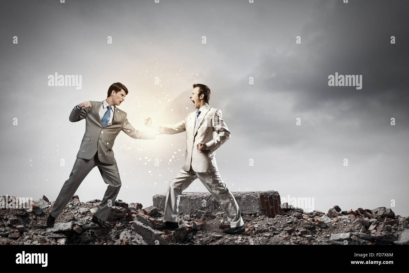 Two businesspeople in anger fighting with each other Stock Photo - Alamy