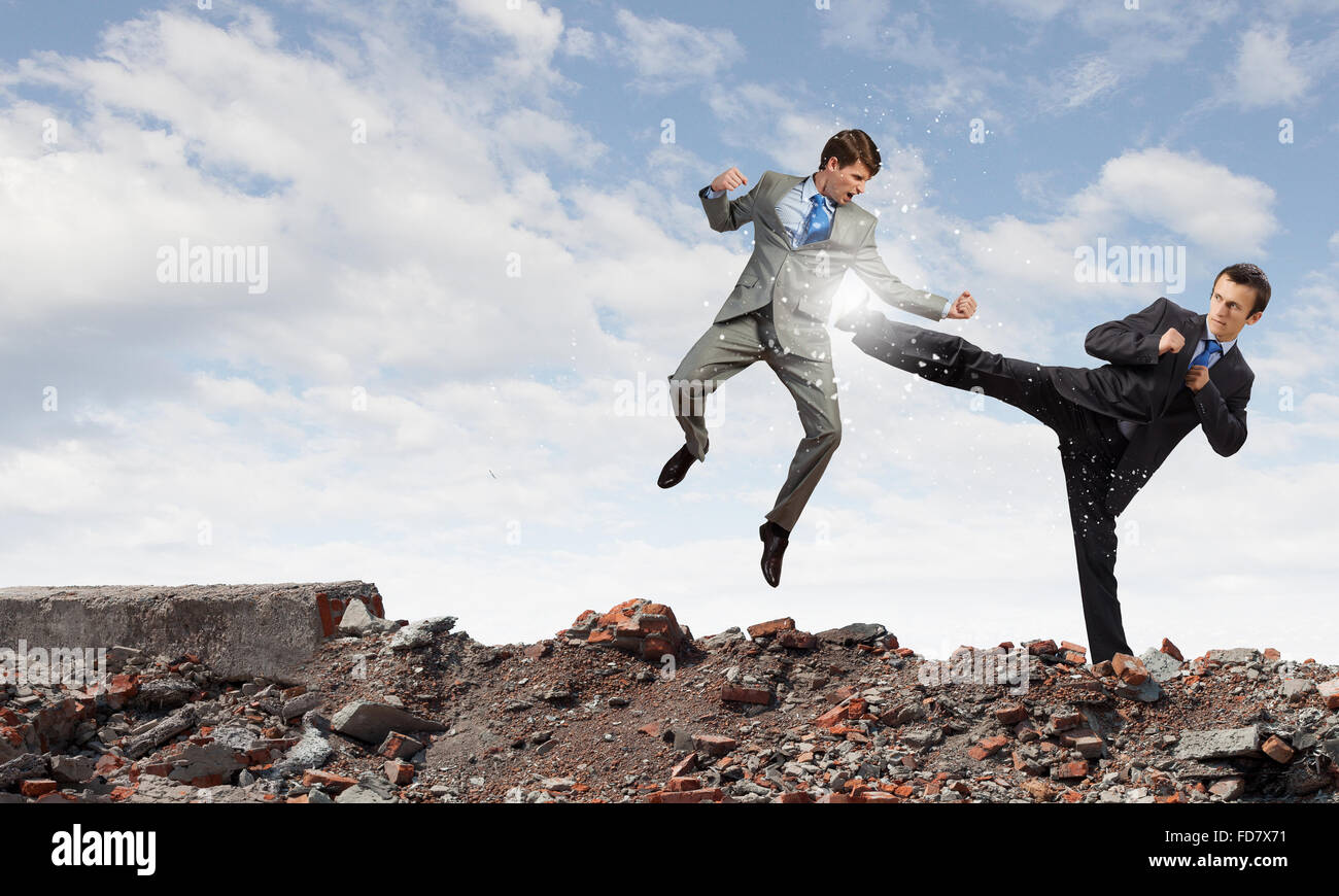 Two businesspeople in anger fighting with each other Stock Photo - Alamy