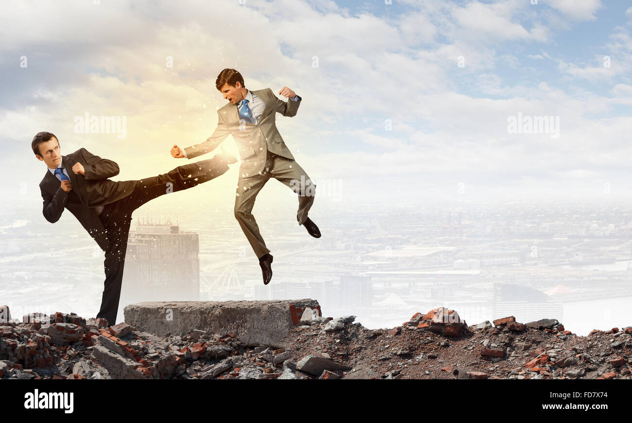 Two businesspeople in anger fighting with each other Stock Photo - Alamy