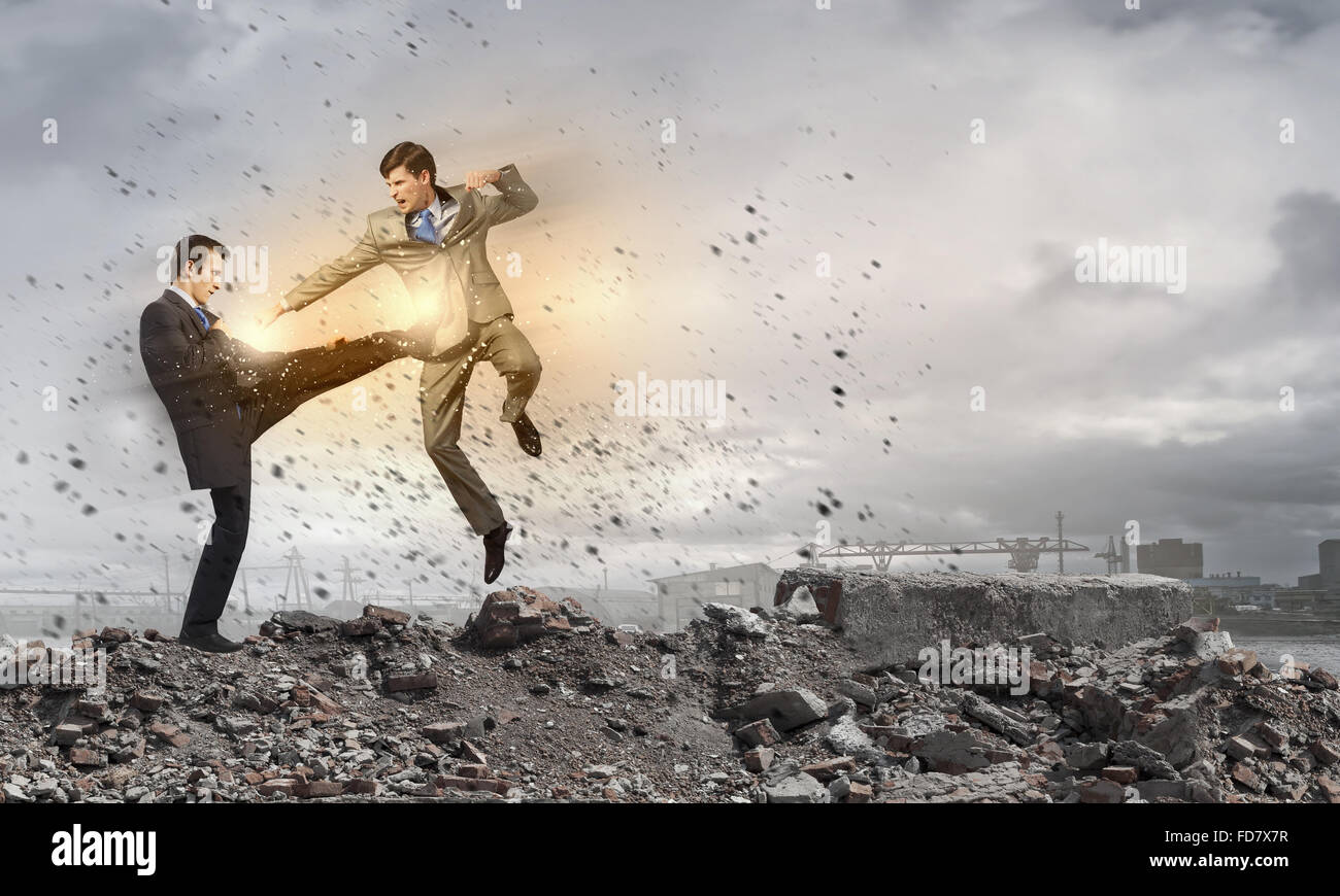 Two businesspeople in anger fighting with each other Stock Photo - Alamy