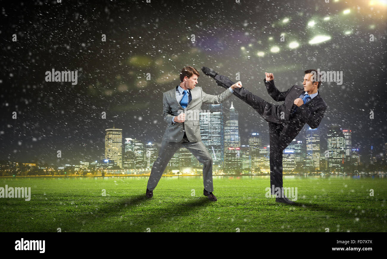 Two businesspeople in anger fighting with each other Stock Photo - Alamy