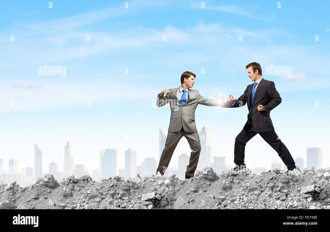 Two businesspeople in anger fighting with each other Stock Photo - Alamy