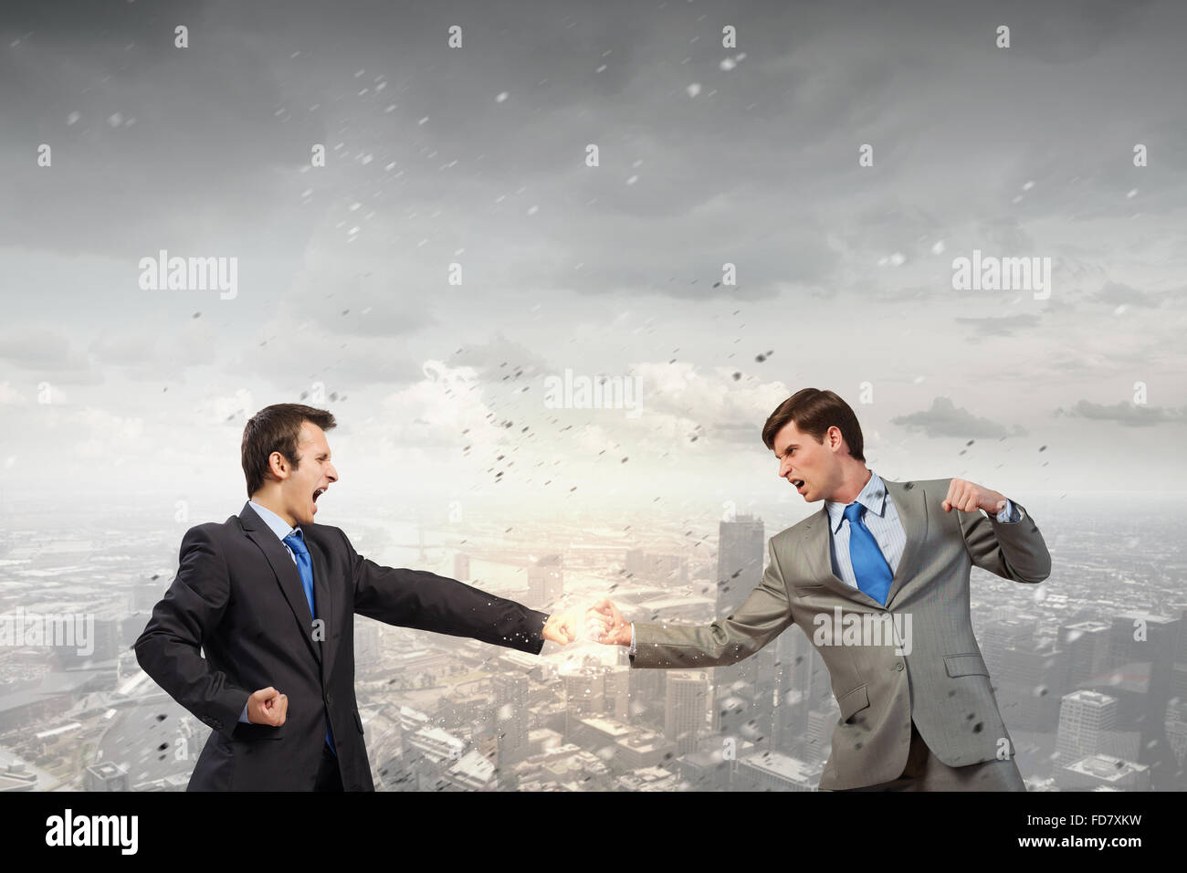 Two businesspeople in anger fighting with each other Stock Photo - Alamy