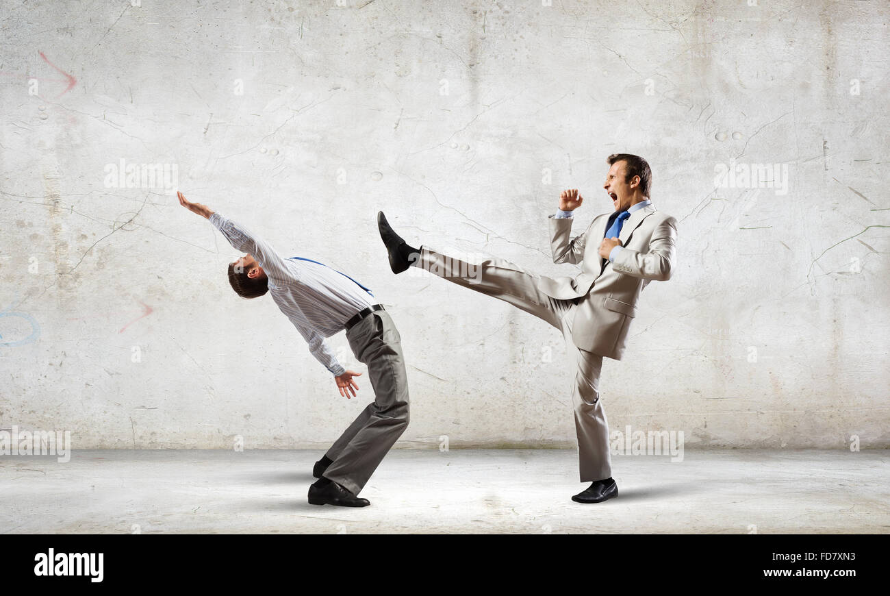 Two businesspeople in anger fighting with each other Stock Photo - Alamy