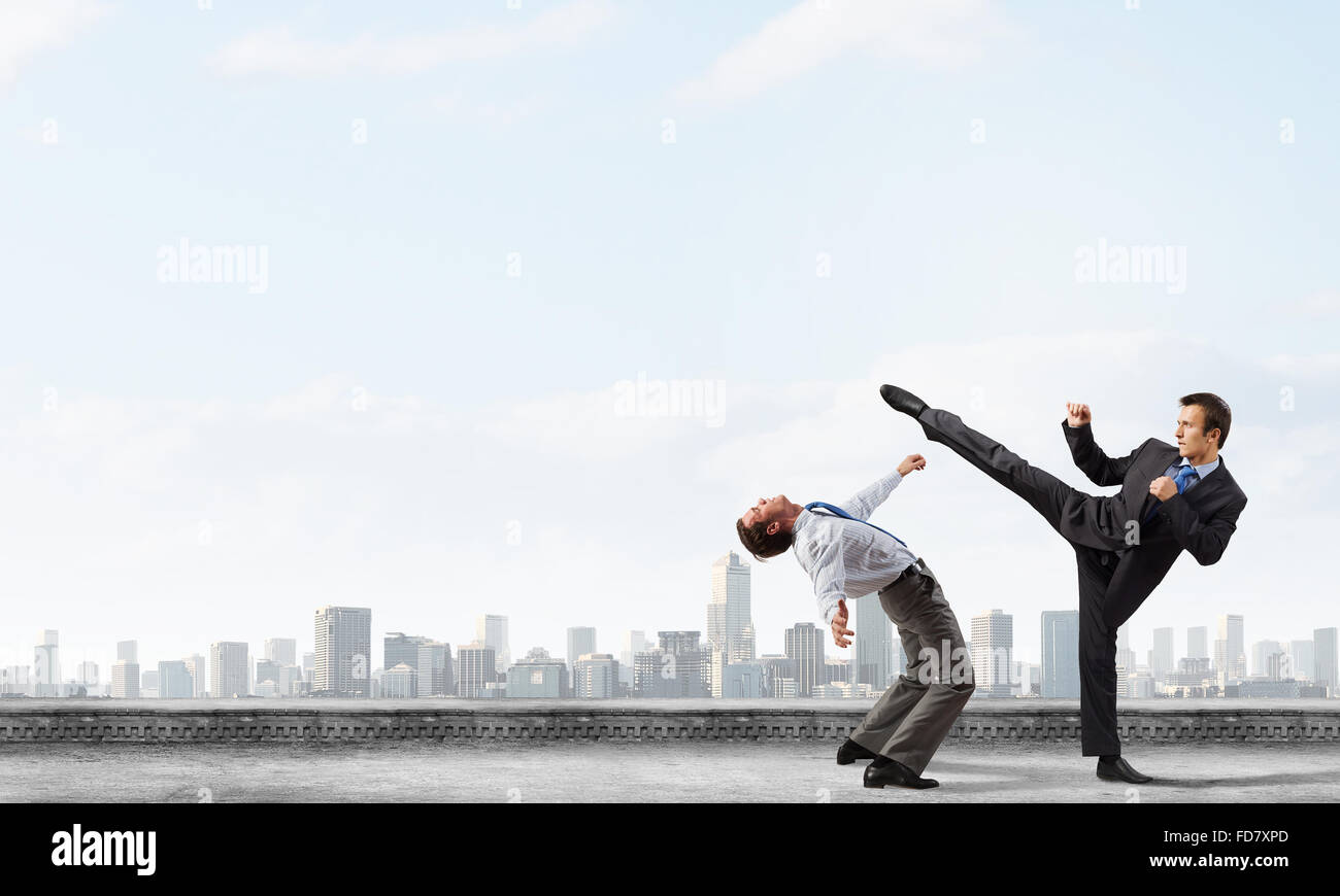 Two businesspeople in anger fighting with each other Stock Photo - Alamy