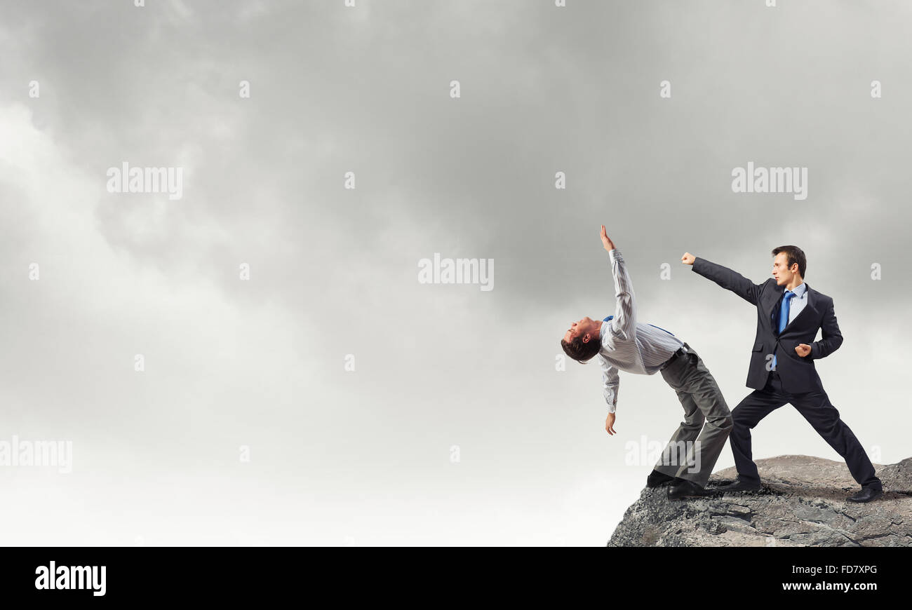 Two businesspeople in anger fighting with each other Stock Photo - Alamy
