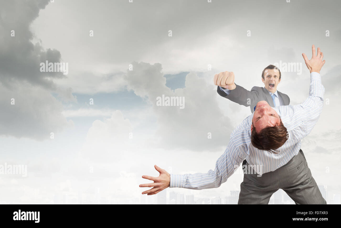 Two businesspeople in anger fighting with each other Stock Photo - Alamy