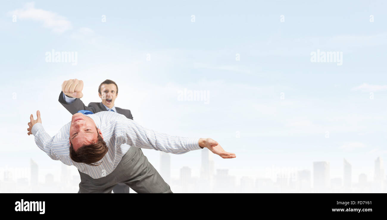 Two businesspeople in anger fighting with each other Stock Photo - Alamy