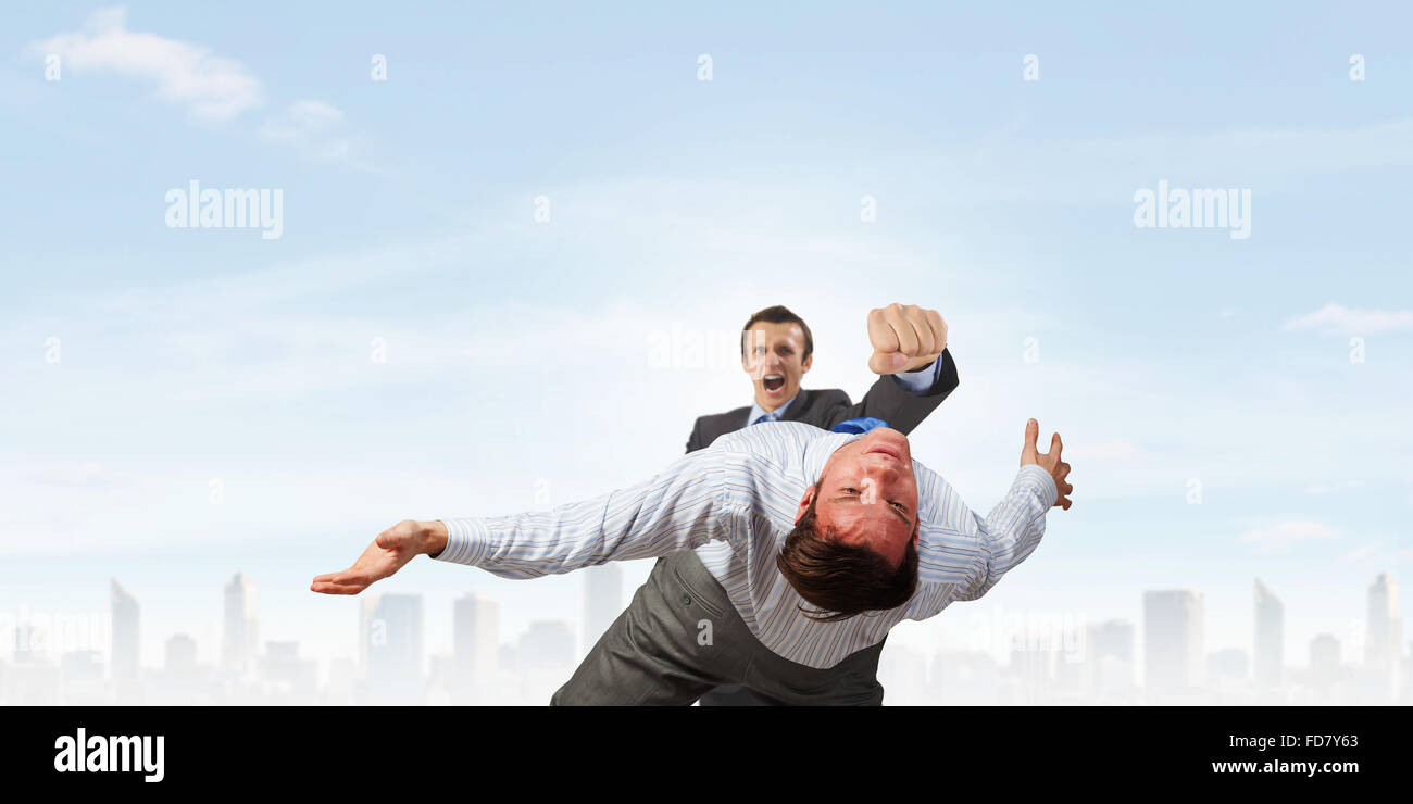 Two businesspeople in anger fighting with each other Stock Photo - Alamy