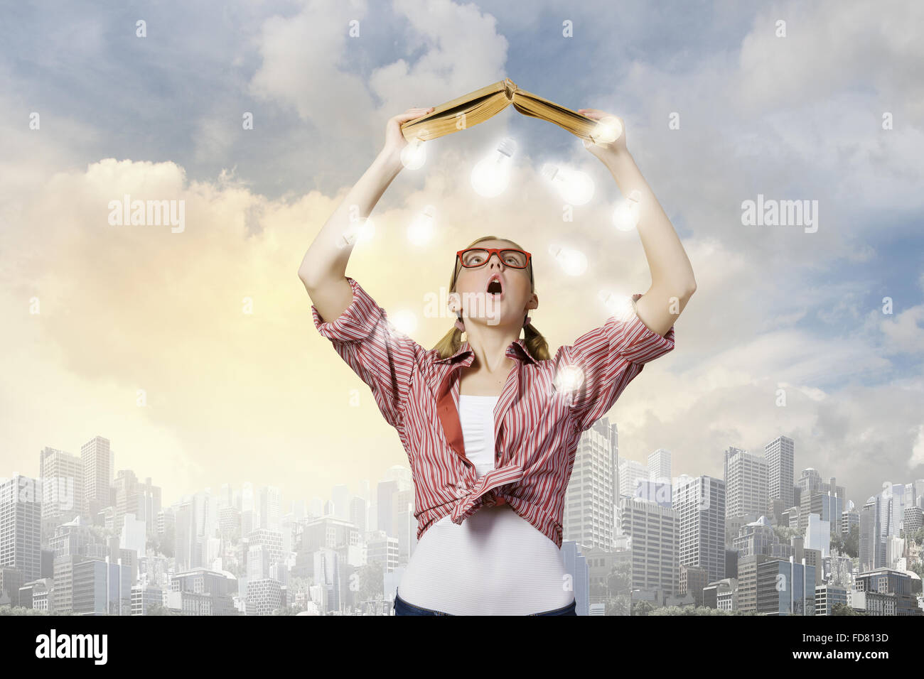 Young funny girl with opened book in hands Stock Photo - Alamy