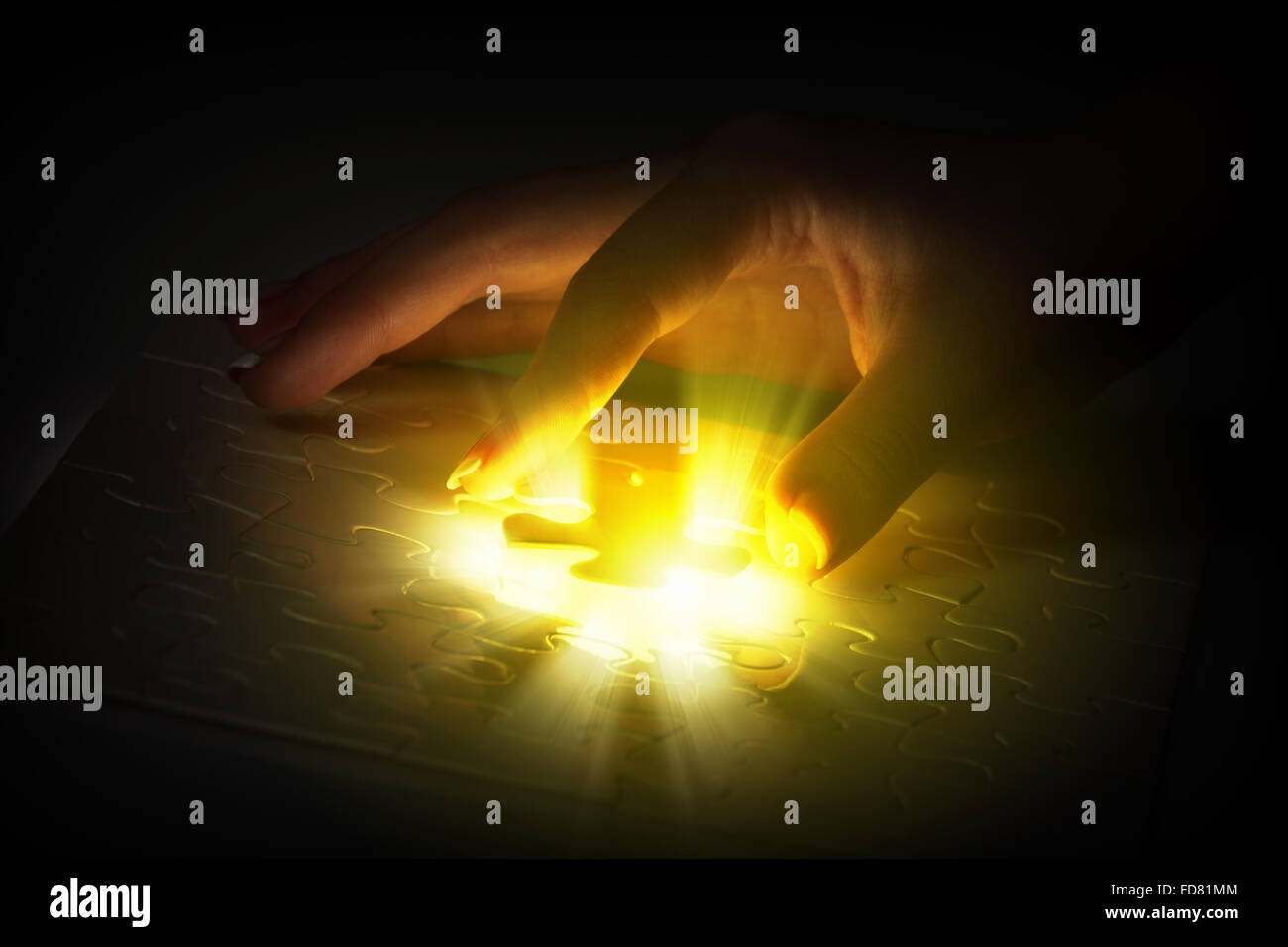 Close up of hands connecting puzzle element and making jigsaw complete ...