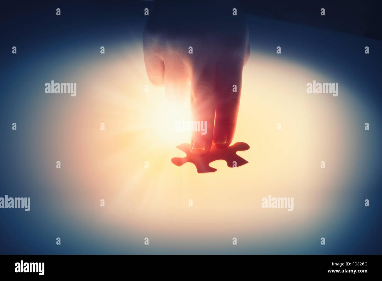 Close up of hands connecting puzzle element and making jigsaw complete ...
