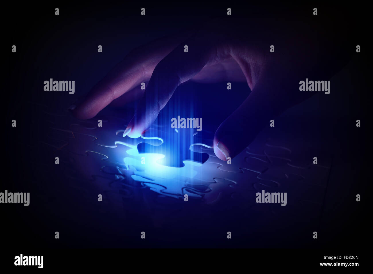 Close up of hands connecting puzzle element and making jigsaw complete ...