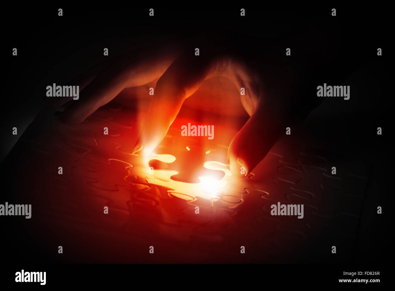 Close up of hands connecting puzzle element and making jigsaw complete ...