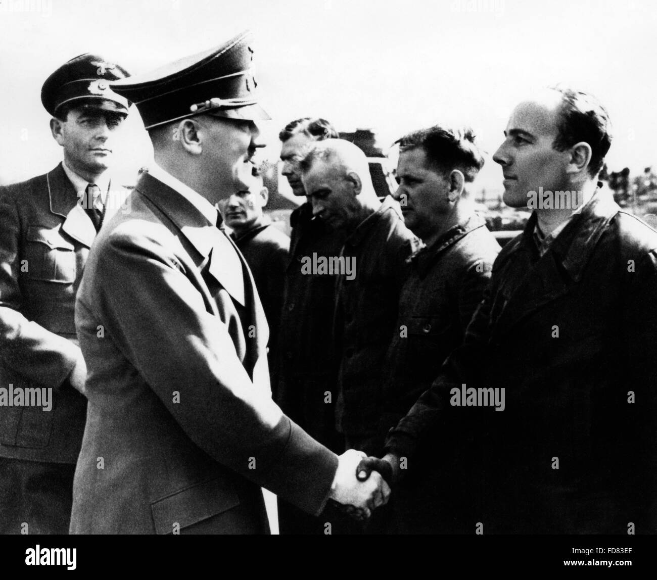 Adolf Hitler greets workers of an armament factory, 1942 Stock Photo ...