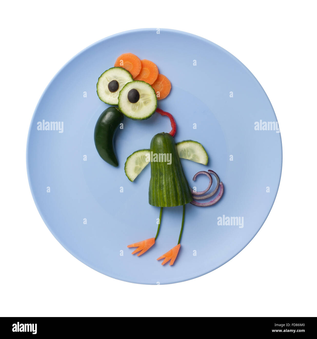 Funny bird made of vegetables on blue plate Stock Photo - Alamy