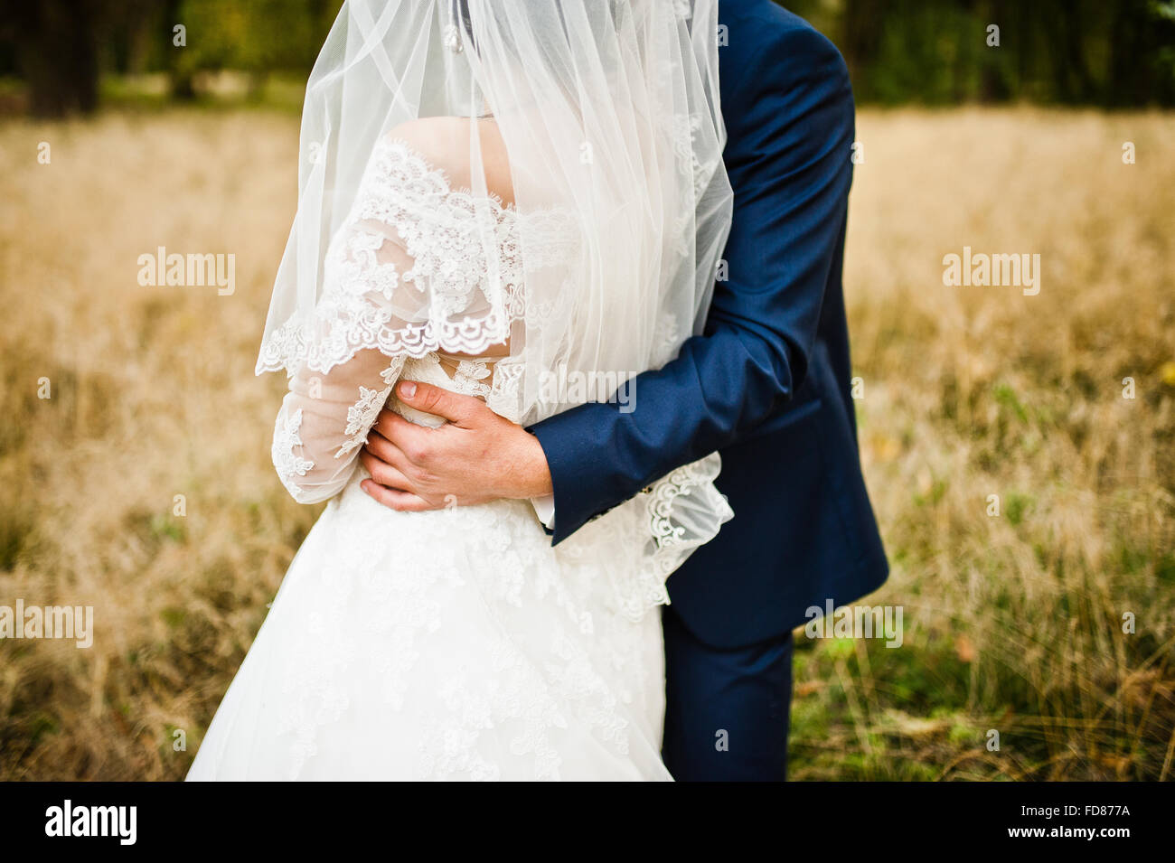 Hand in hand of stylish wedding couple Stock Photo - Alamy