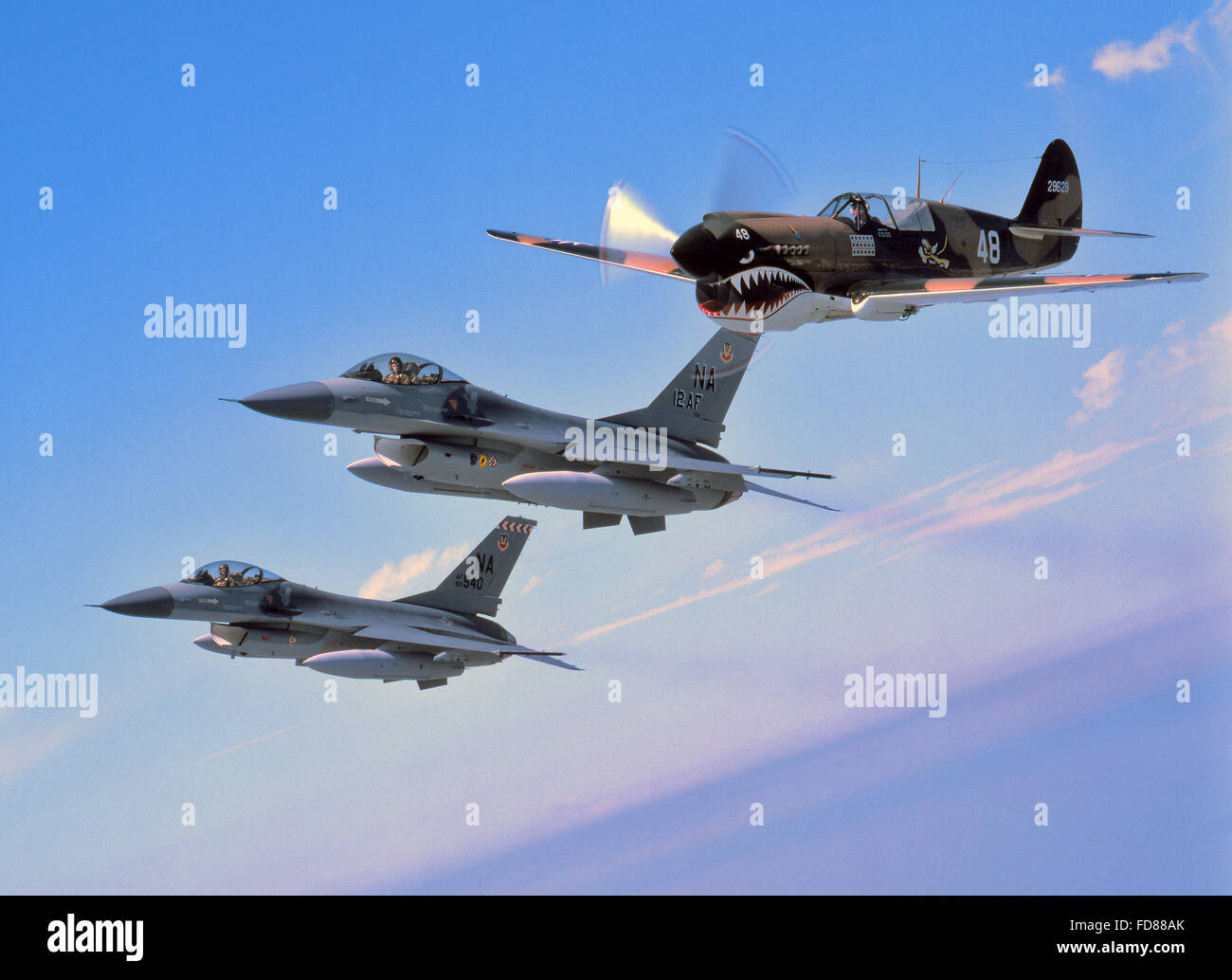 Vintage WWII fighter, with two modern-day fighters flying Stock Photo ...