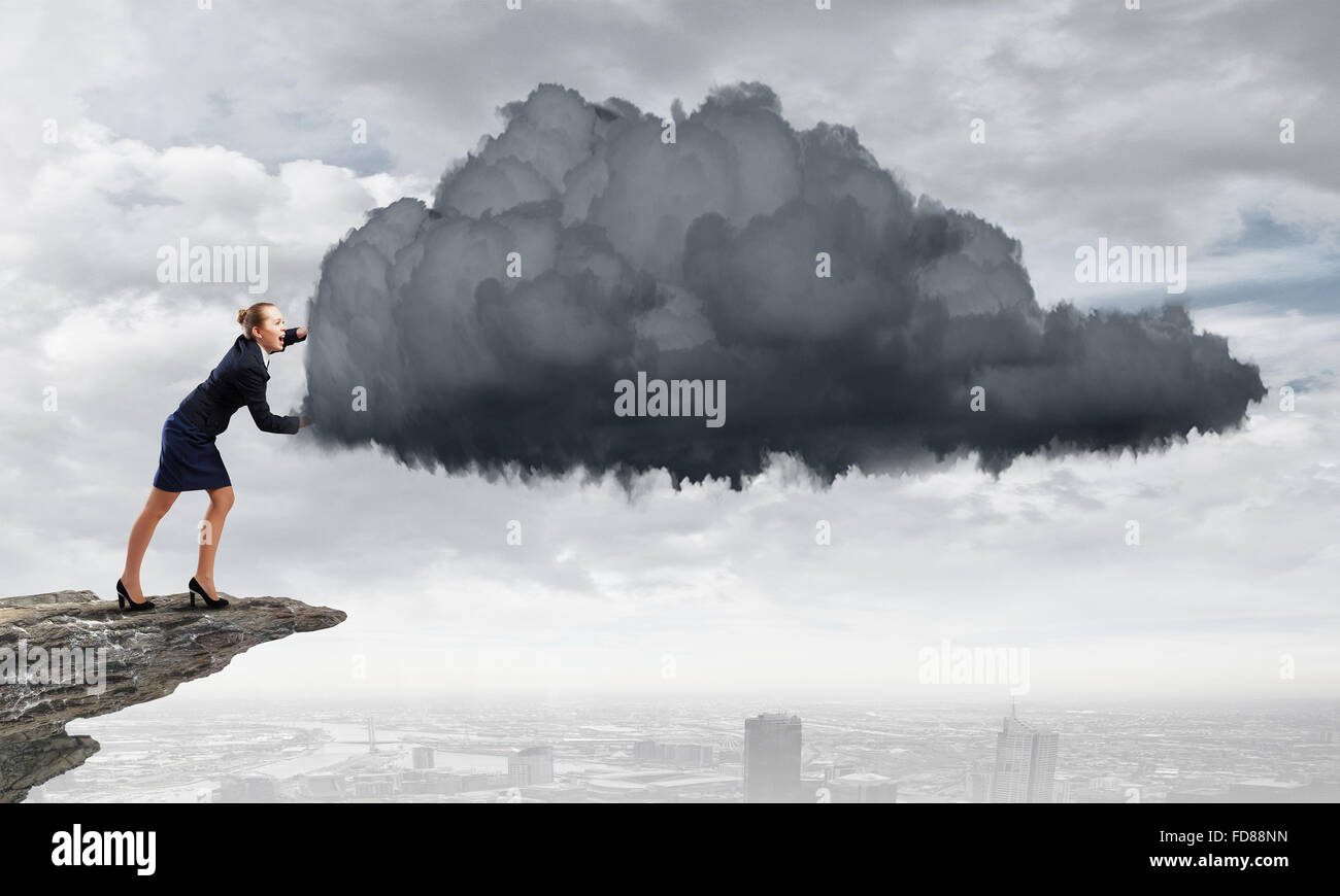 Attractive businesswoman pushing big cloud with effort Stock Photo - Alamy