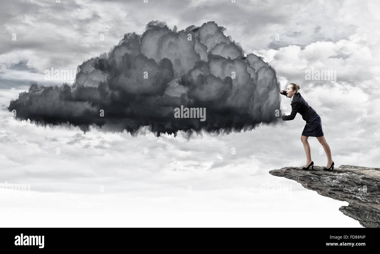 Attractive businesswoman pushing big cloud with effort Stock Photo - Alamy