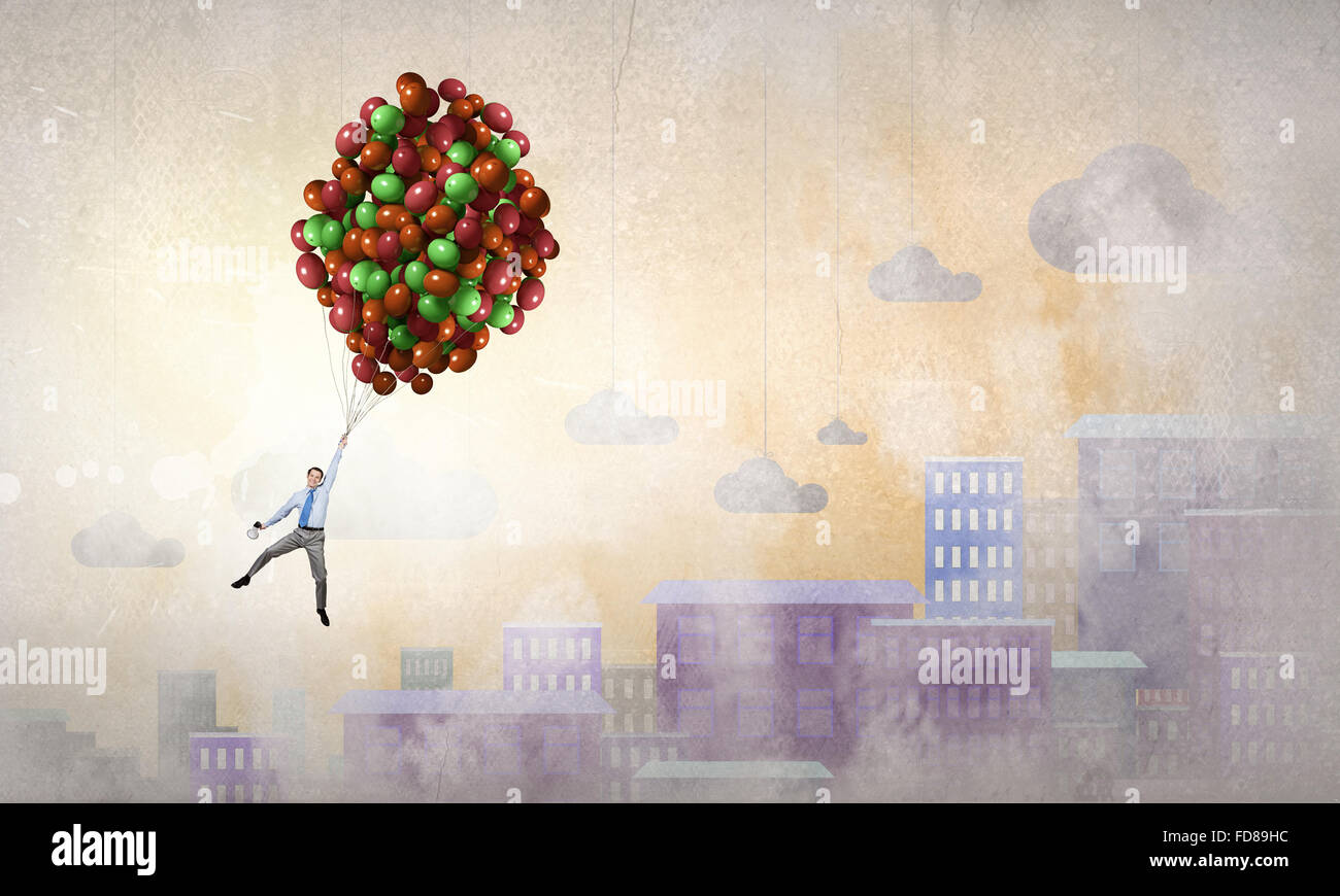 Young successful businessman flies on bunch of colorful balloons Stock ...