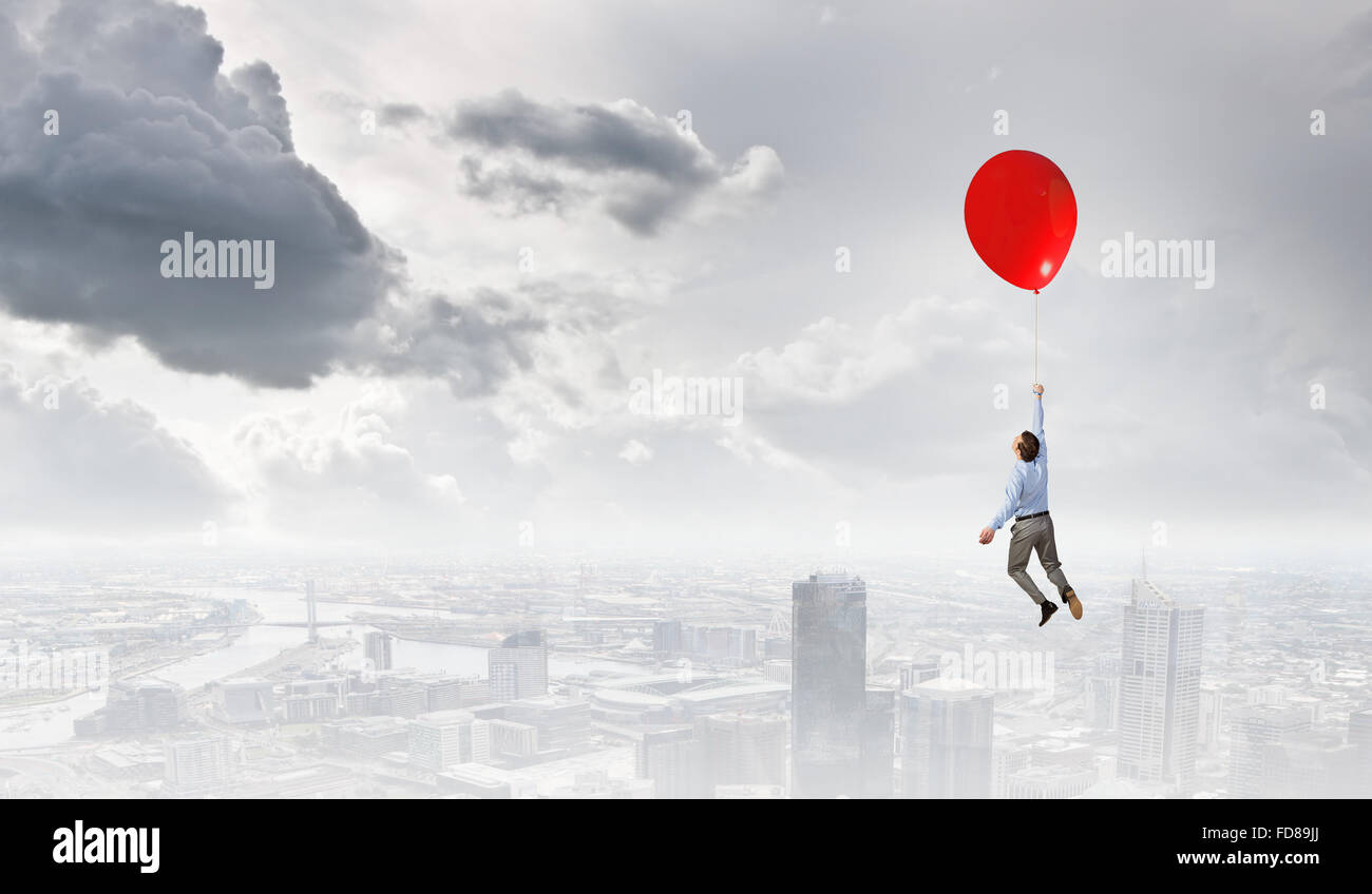 Young successful businessman flies on colorful balloon Stock Photo - Alamy
