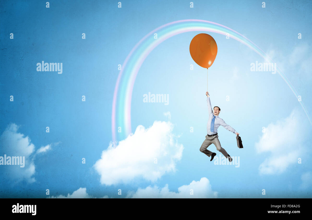 Young successful businessman flies on colorful balloon Stock Photo - Alamy