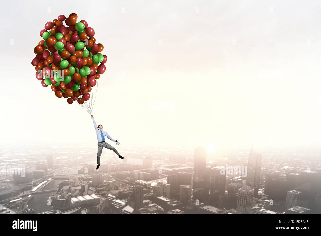Young successful businessman flies on bunch of colorful balloons Stock ...