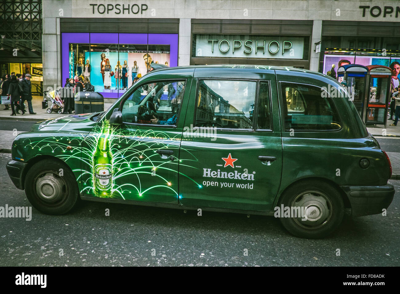 A London Taxi Cab with green livery for Heinken in Oxford Street Stock ...