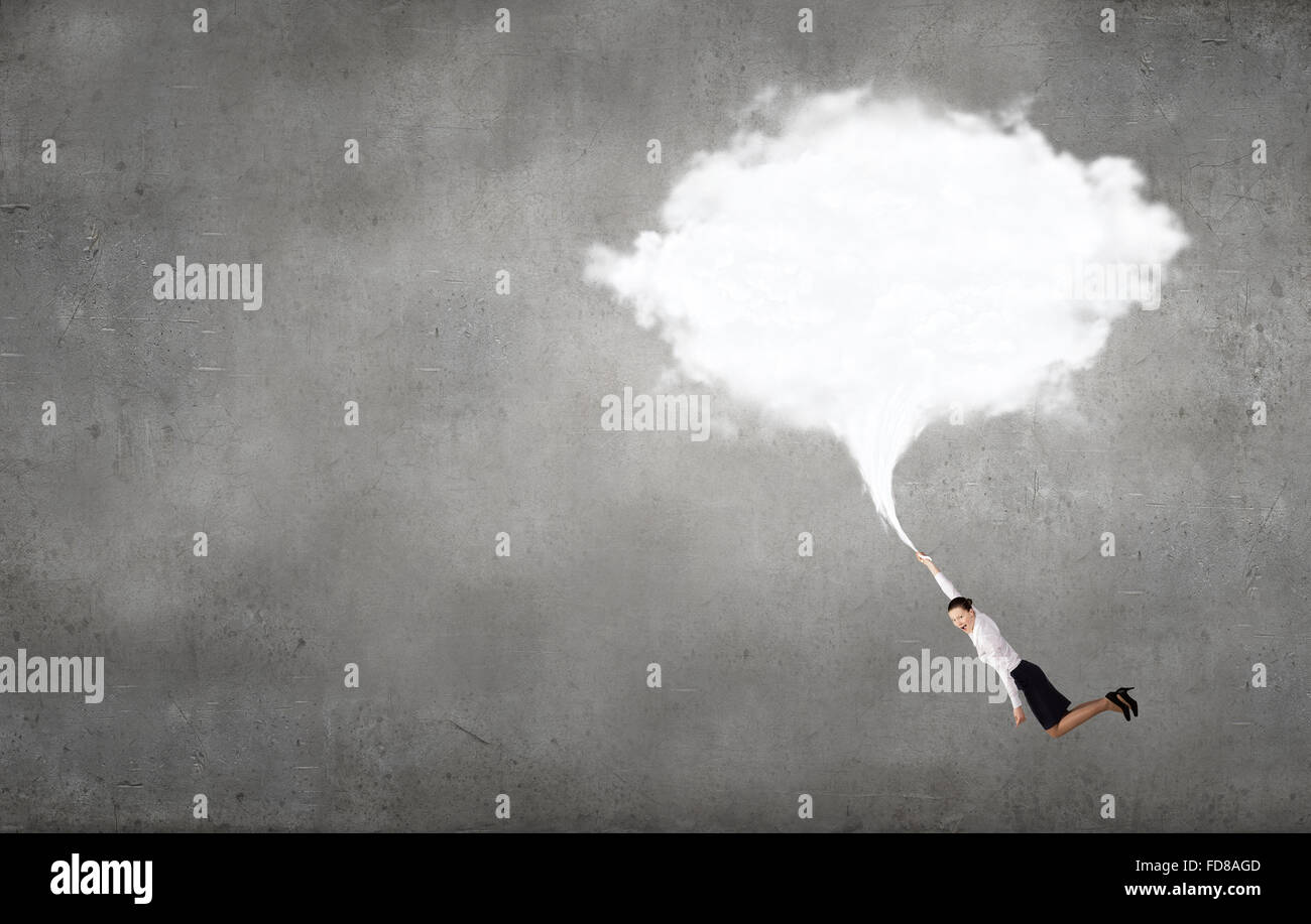 Young determined businesswoman flying high in sky on cloud Stock Photo ...