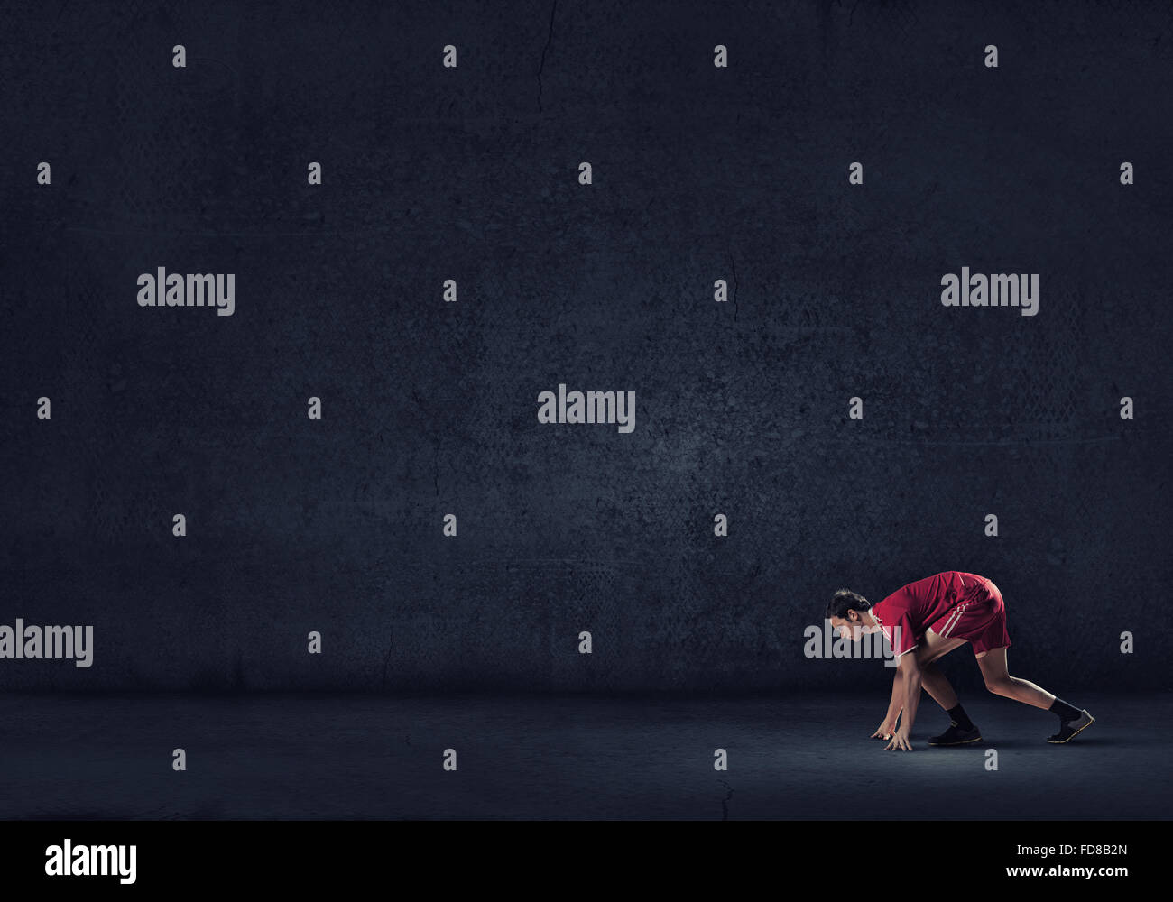 Running man in red sport wear on black background Stock Photo - Alamy
