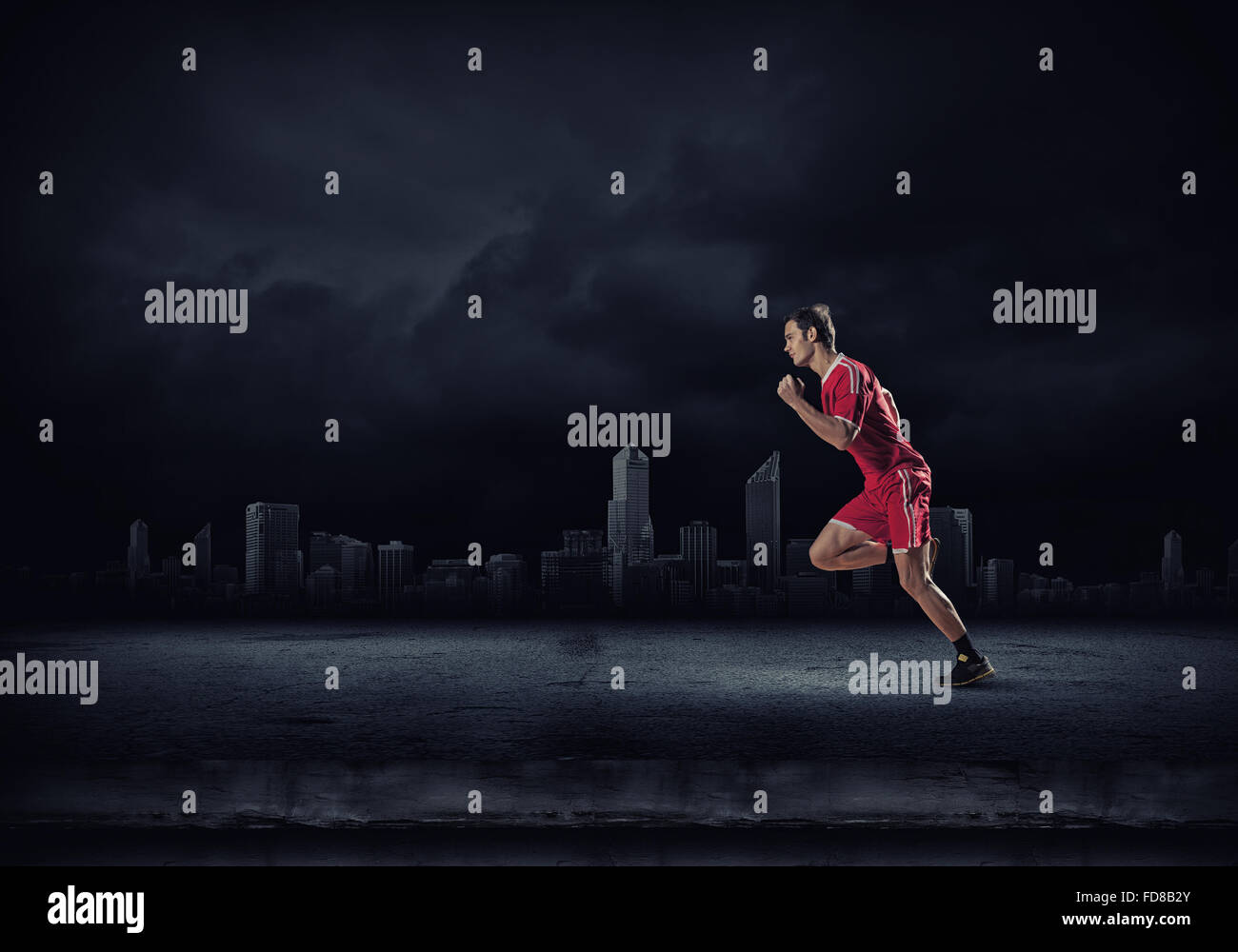 Running man in red sport wear on black background Stock Photo - Alamy