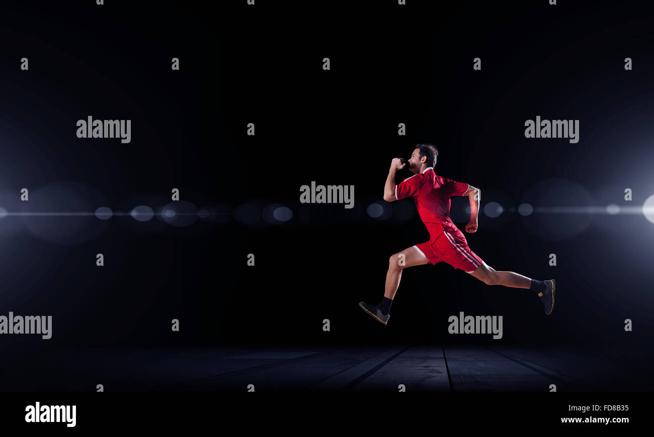Running man in red sport wear on black background Stock Photo - Alamy